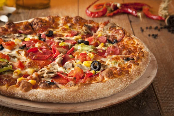 Delicious Italian supreme Pizza — Stock Photo © gorkemdemir #55571717