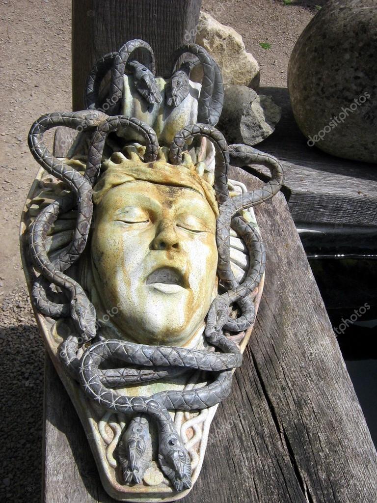 Sculpture of snakes biting a man head or brain. torture. pain ...