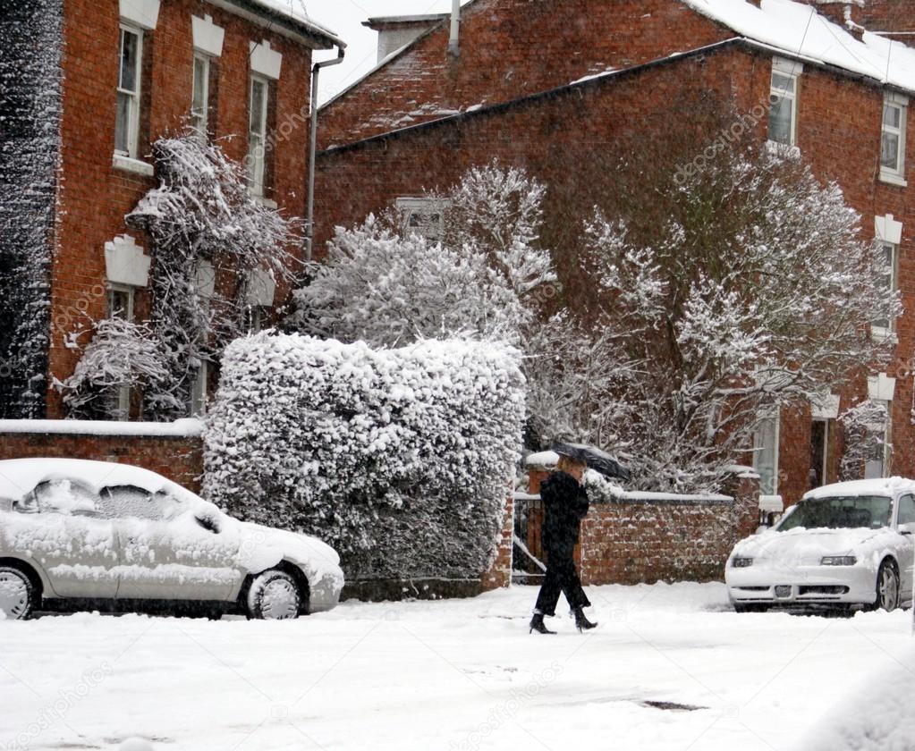 Urban snow scene. A woman walking in the snow — Stock Photo © rose4 ...