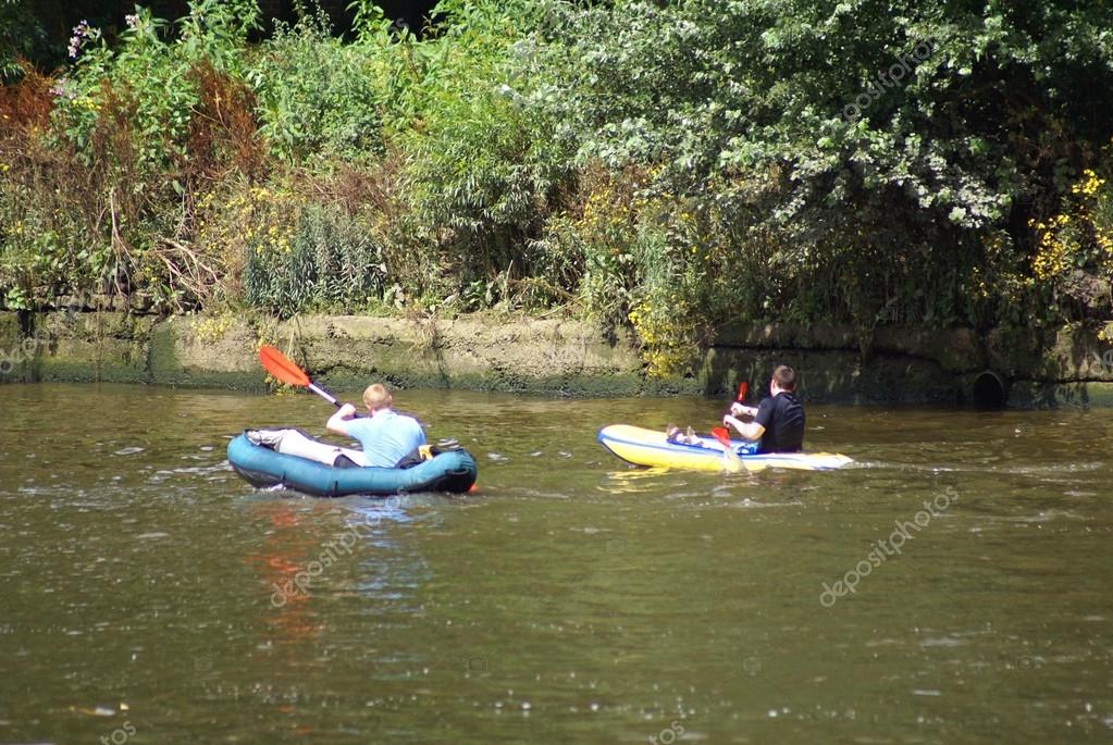 Men rowing inflatable boats Stock Photo by ©rose4 79509296