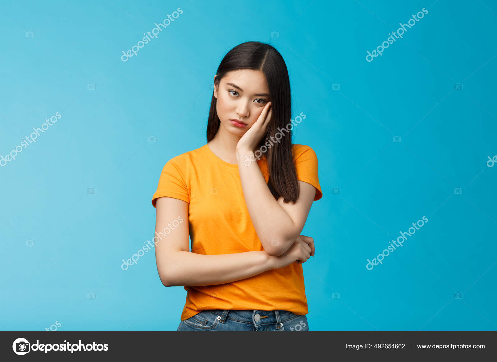 Sad bored asian female student attend boring uninteresting lecture lean ...