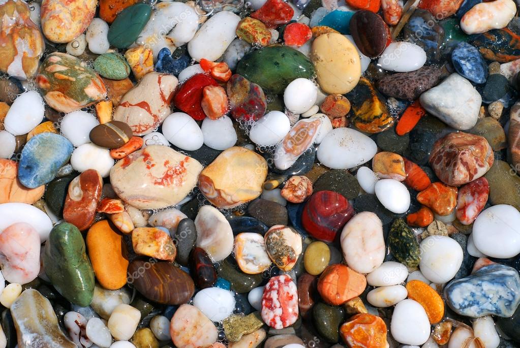 Multicolored sea pebbles in water Stock Photo by ©tachipa 100045514