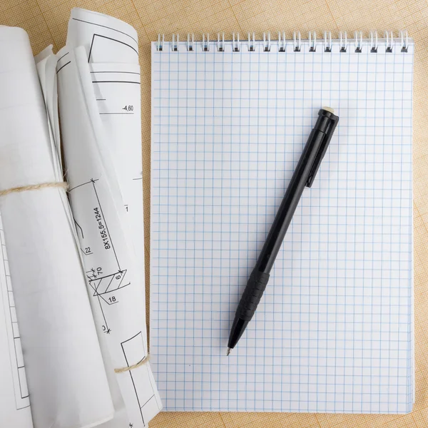 Architectural project, blueprints, blueprint rolls near checkered blank ... Architectural project, blueprints, blueprint rolls near checkered blank ...