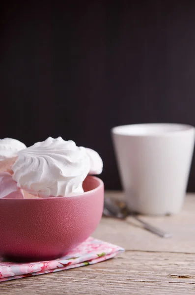 Sweet marshmallows in red bowl on wooden table - Stock Image - Everypixel