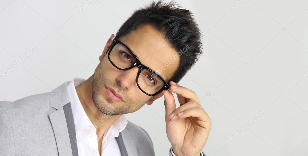 Handsome man holding eyeglasses Stock Photo by ©rdrgraphe 114655690