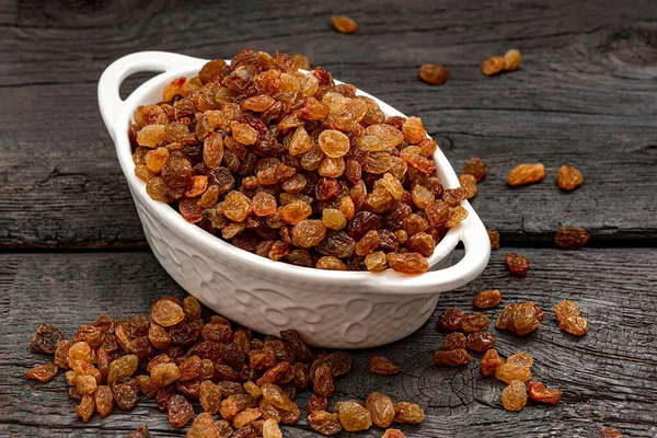 Raisins are beautifully dried highest grade in white bowl. Delicious ...