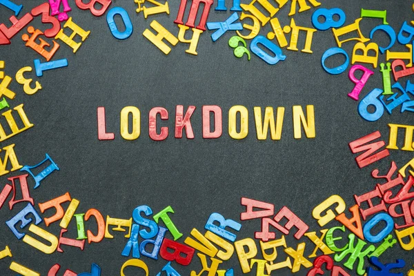 Lockdown, word from bright color letters on black background. - Stock ...