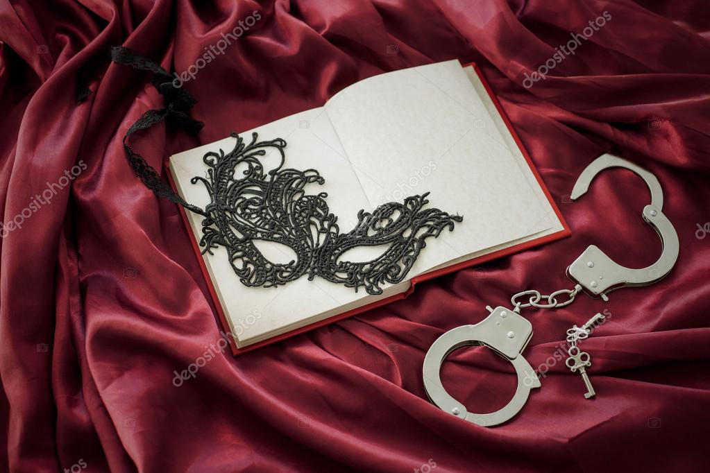 Book, mask and handcuffs Stock Photo by ©grinvalds 91246290