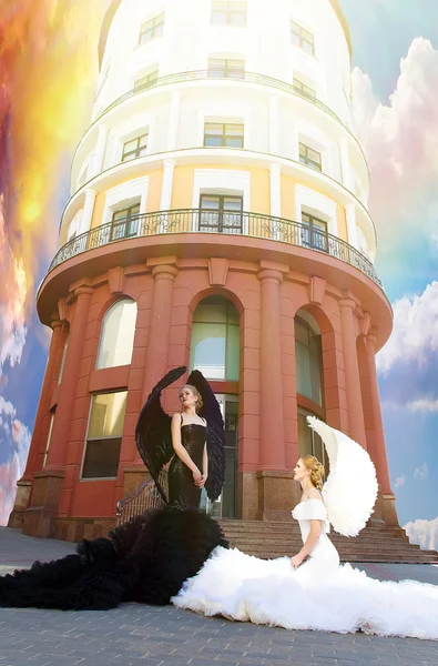 Two angels. black angel standing over white angel — Stock Photo © nn ...