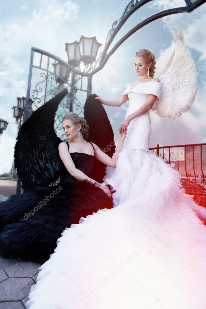 Two angels. black angel standing over white angel — Stock Photo © nn ...