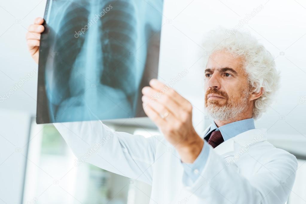 Radiologist checking patient's x-ray images Stock Photo by ©stockasso ...