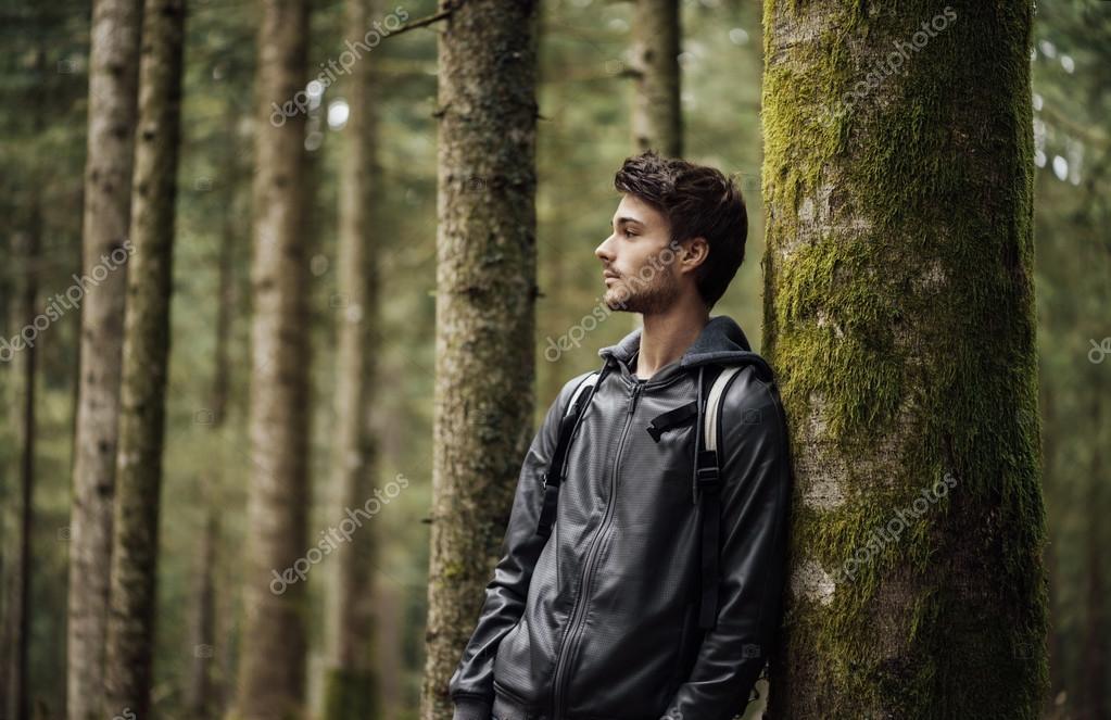Young man exploring a forest Stock Photo by ©stockasso 124546948