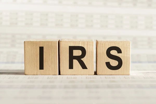 IRS abbreviation - Internal Revenue Service, on wooden cubes on a light ...