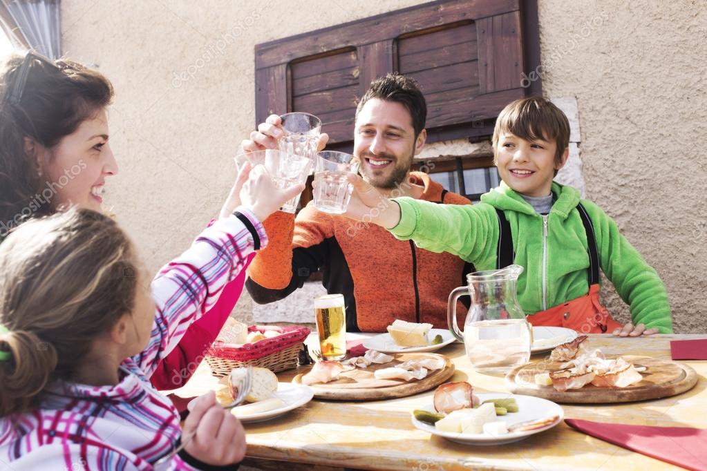 Family cheers in a mountain chalet — Stock Photo © Cristina Conti #73116739 Family cheers in a mountain chalet — Stock Photo © Cristina Conti #73116739