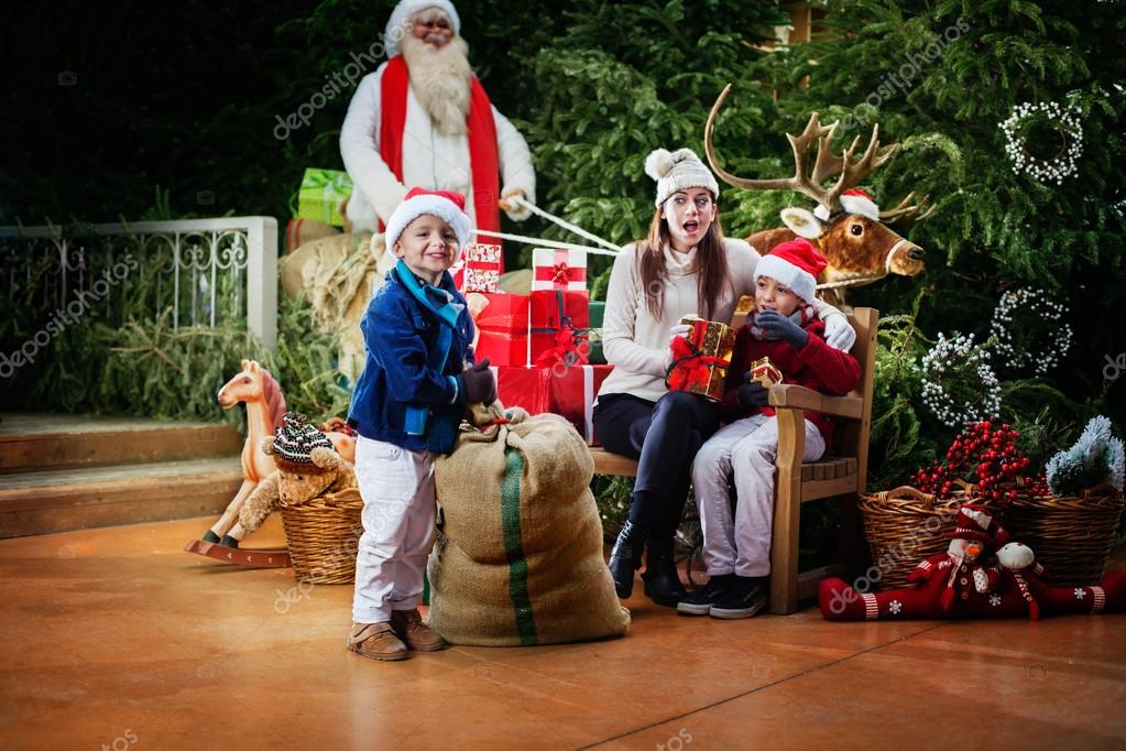 Little helper of Santa Claus carrying a sack of gifts — Stock Photo ...