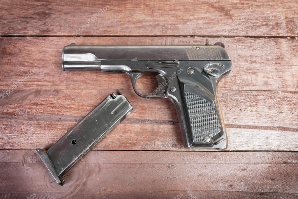 Semi-automatic 9mm gun isolated on wooden background Stock Photo by ...