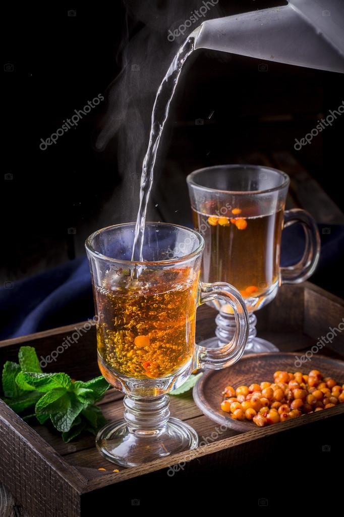 Hot tea flowing in glass cup with berries. Stock Photo by ©vla-u 103271374