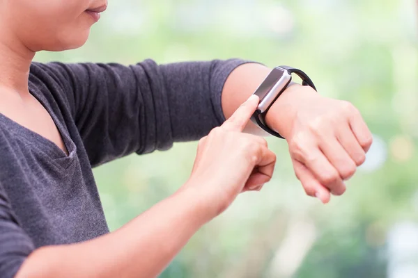 Young woman using her smart watch at home - Stock Image - Everypixel