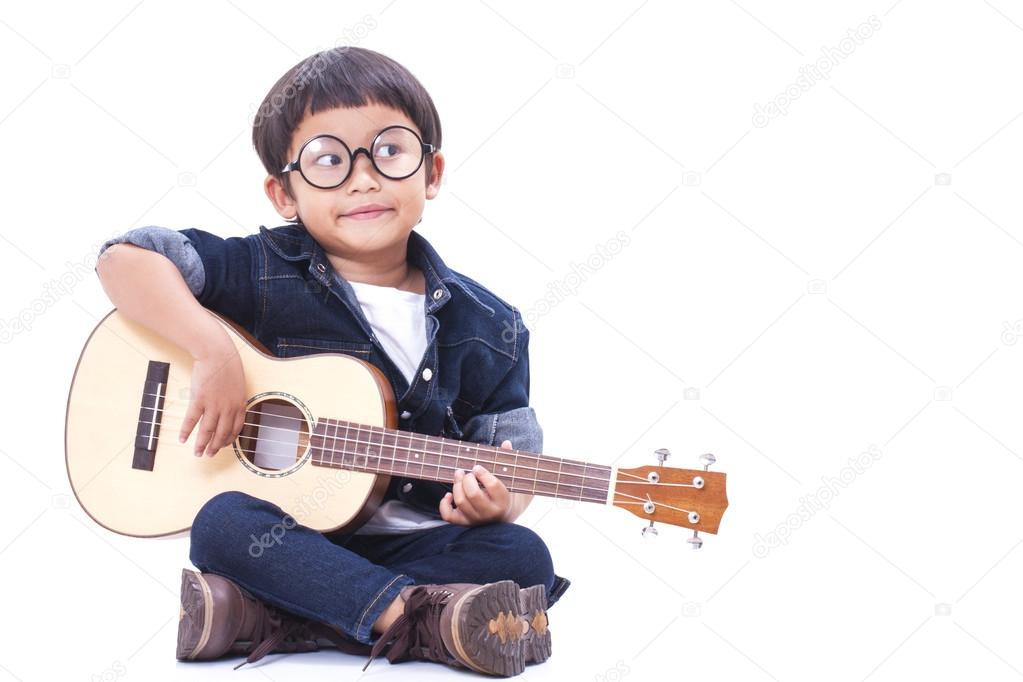 Cute boy playing the ukulele on white background Stock Photo by ...