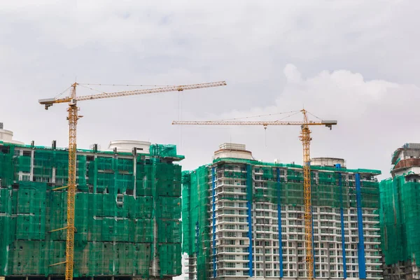 Image of a building in progress with security net around it. High ...