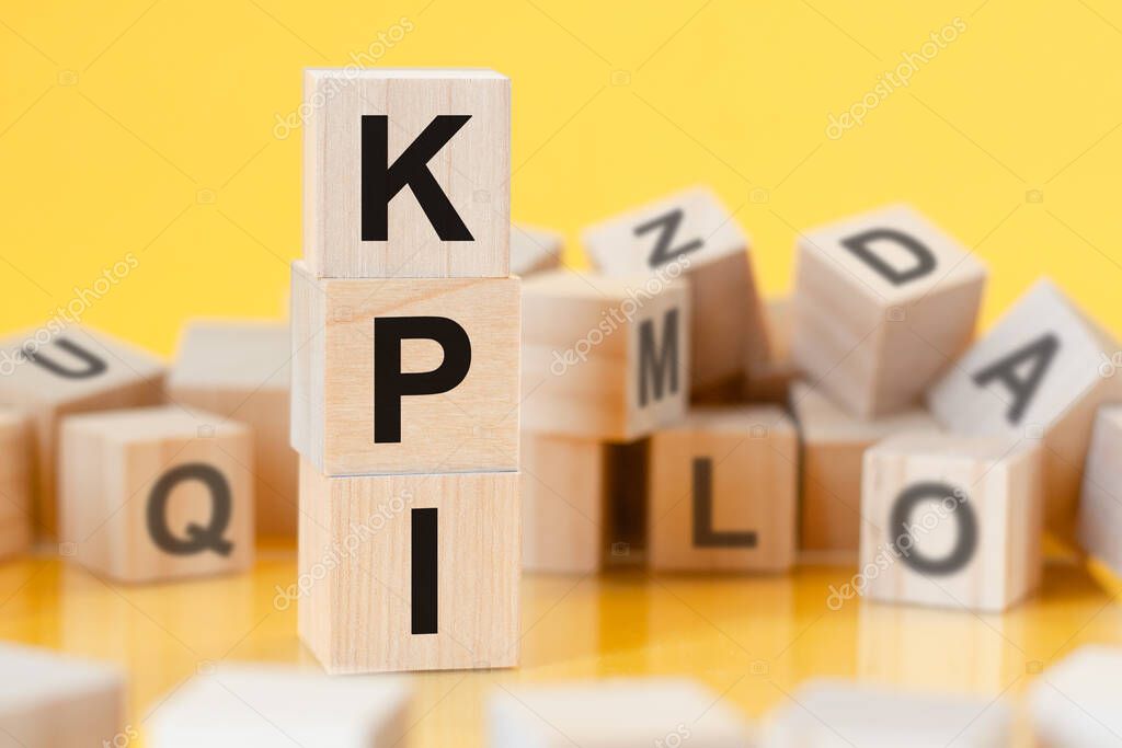 Wooden Cubes With Letters Kpi Arranged In A Vertical Pyramid Yellow