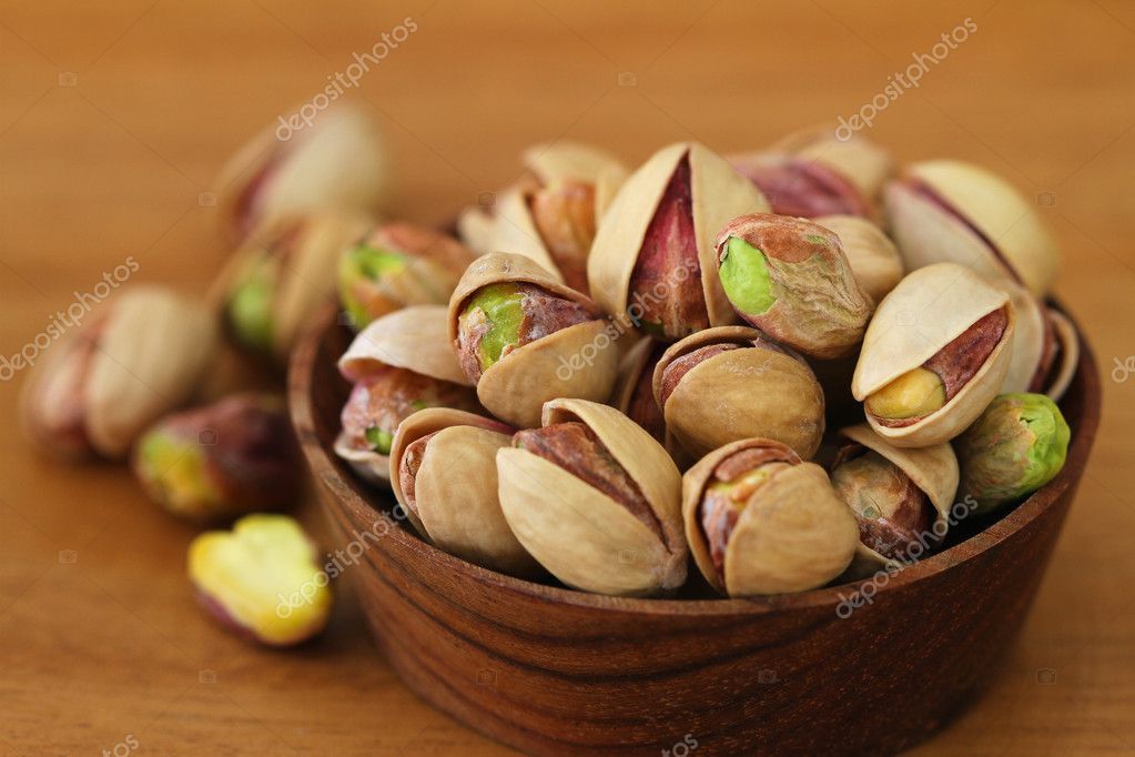 Pistachios with and without shell in wooden bowl — Stock Photo ...