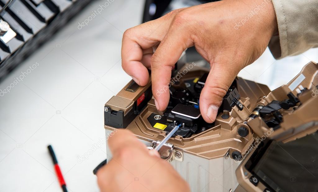 Technicians using fusion machine fiber optic cables. Stock Photo by ...