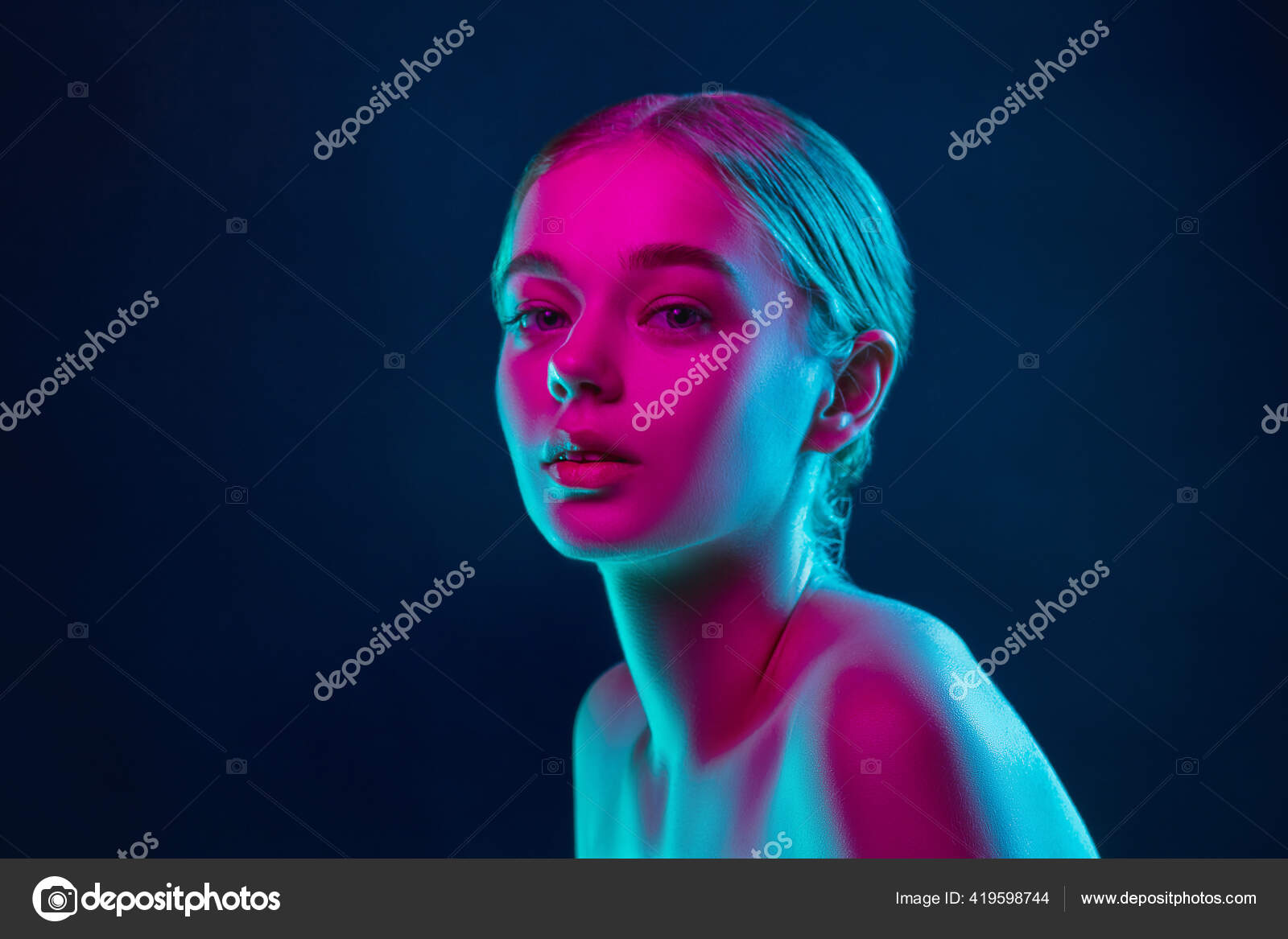 Portrait of female fashion model in neon light on dark studio ...