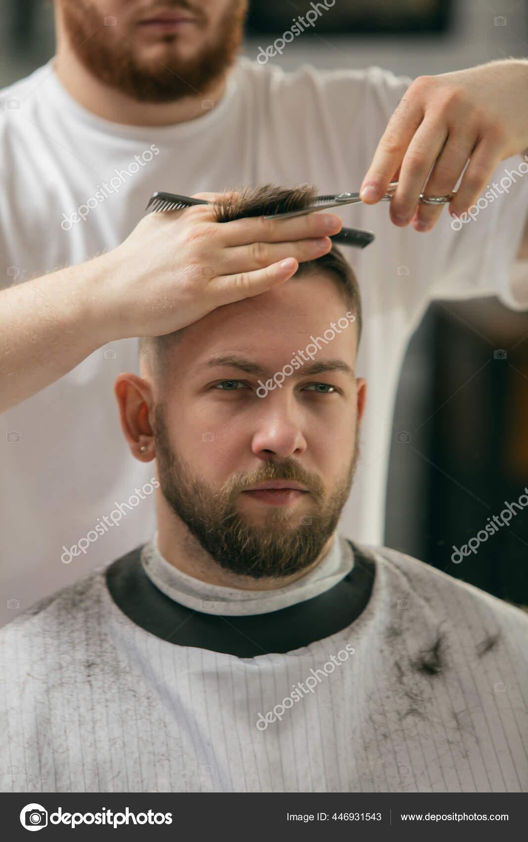 Close up master barber, stylist does the hairstyle to guy, young man ...