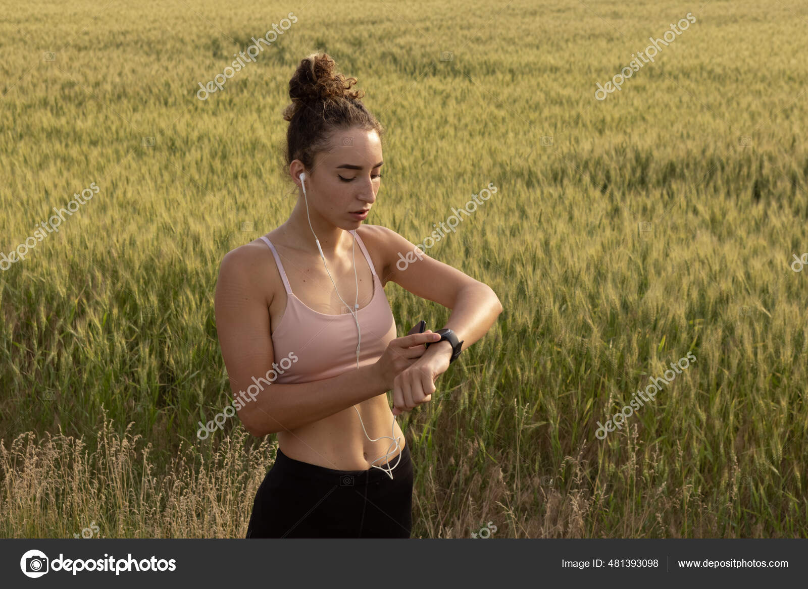 Young female runner, athlete is jogging at road in summer sunshine. Beautiful caucasian woman ...