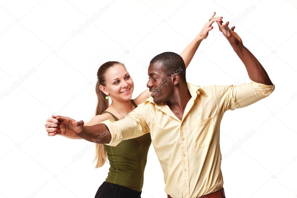 Young couple dances Caribbean Salsa, studio shot Stock Photo by ...