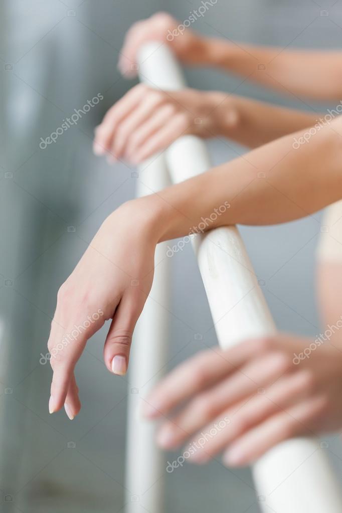The hands of two classic ballet dancers at barre Stock Photo by ...