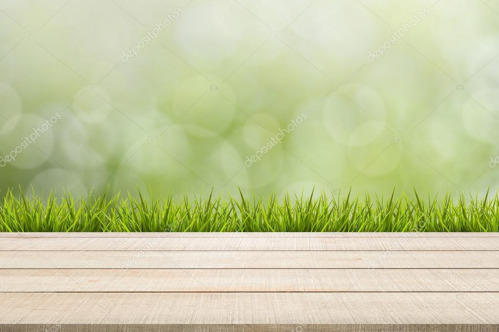 Wood table top panel and grass on green background — Stock Photo ...