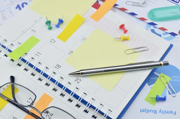 Pencil with post It notes and pin on business diary page Stock Photo by ...