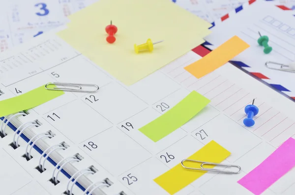 Pencil with post It notes and pin on business diary page Stock Photo by ...