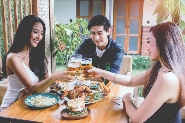 Two asian woman and one men.Drinking beer,are smile.Group celebration party eating happy ...
