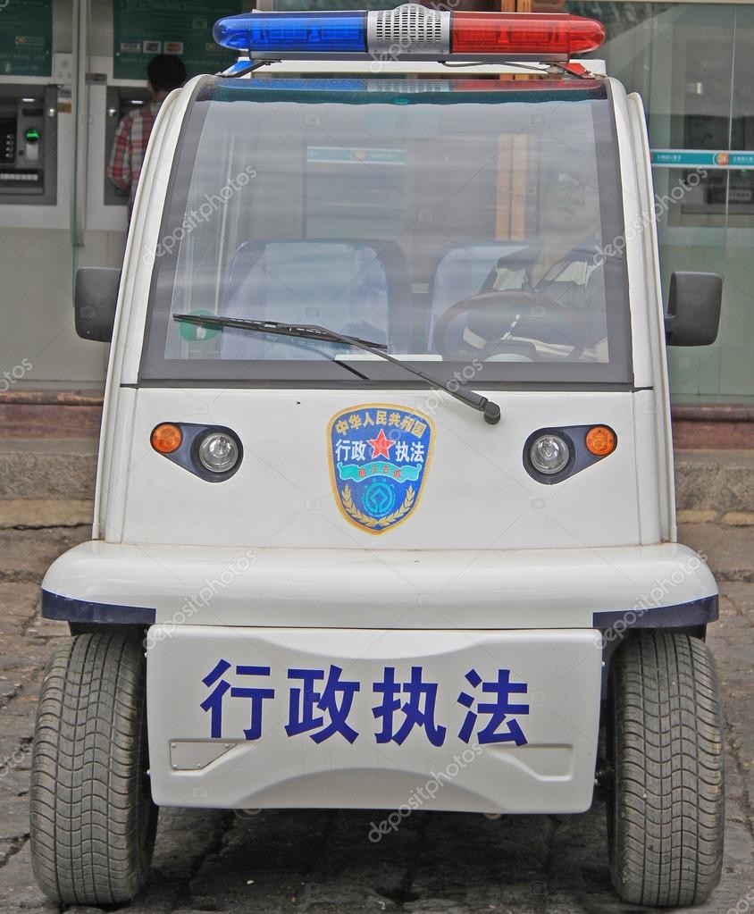 Police officer is sitting inside the car in Lijiang, China — Stock ...