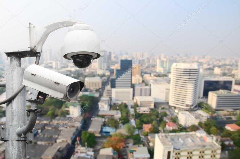 Surveillance Security Camera or CCTV over city Stock Photo by ...