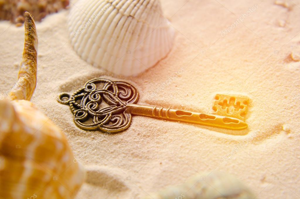 Lost treasure key on sand — Stock Photo © kwanchaidp #80723634