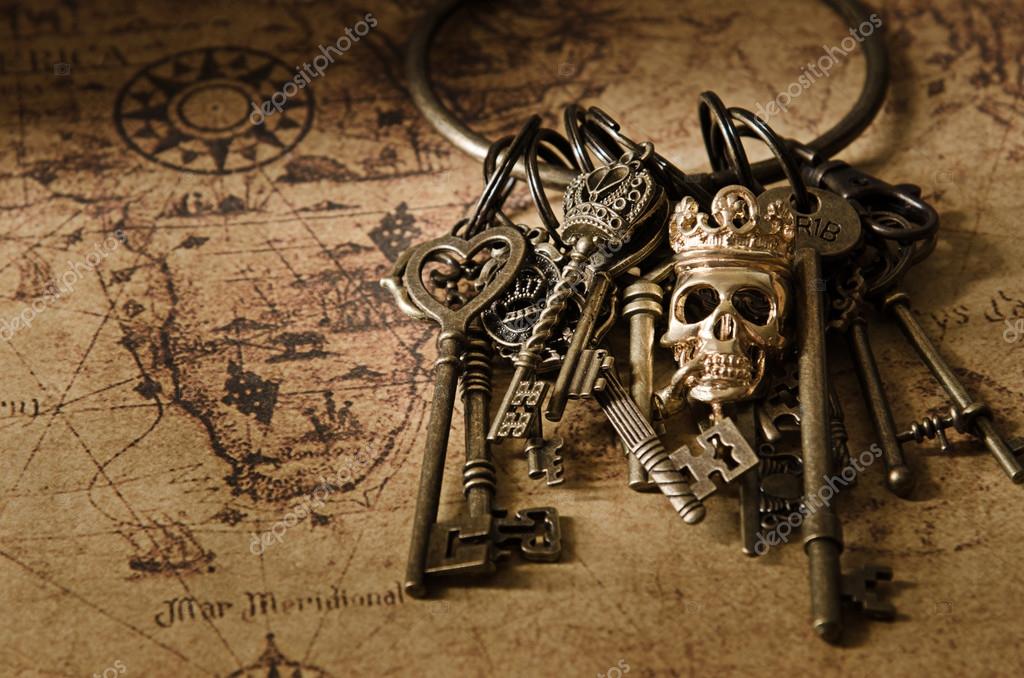 Treasure key on old map Stock Photo by ©kwanchaidp 82112650