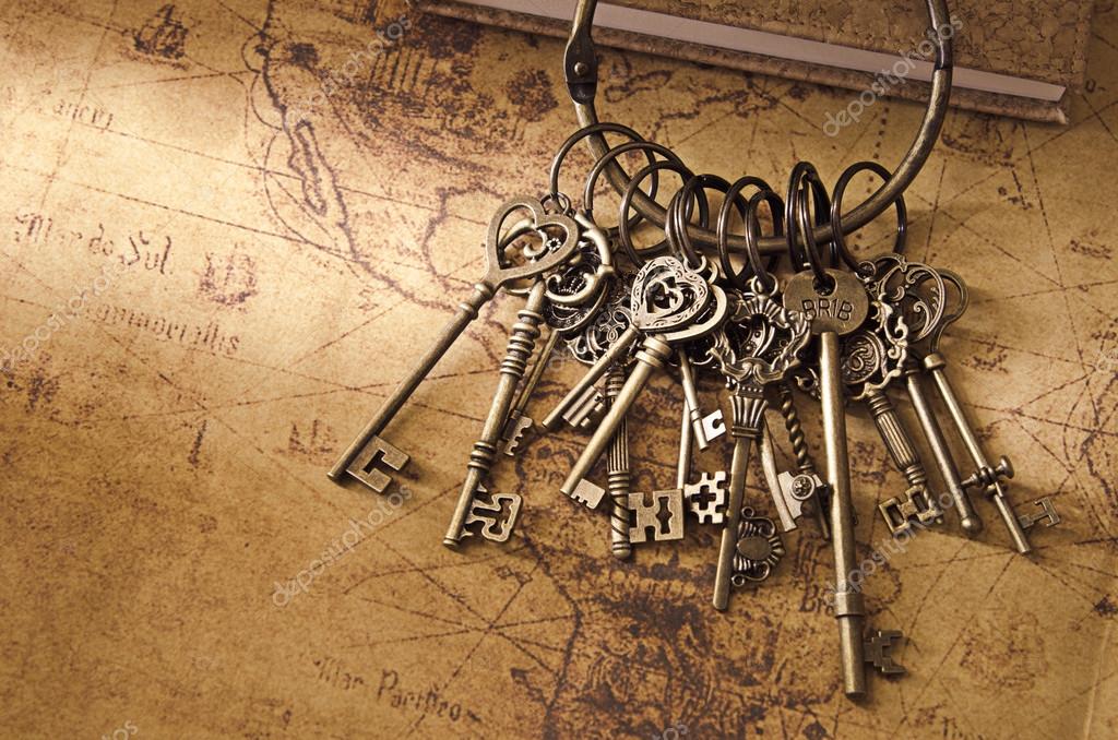 Treasure key on old map Stock Photo by ©kwanchaidp 82540060