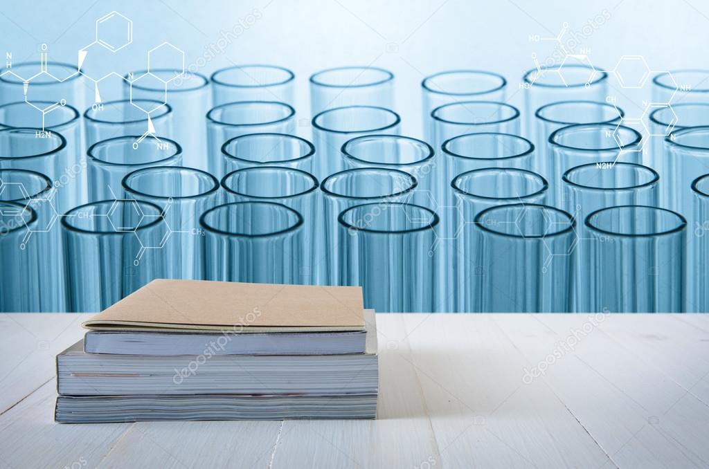 Stack of book on white wooden table with scientist laboratory te Stock ...