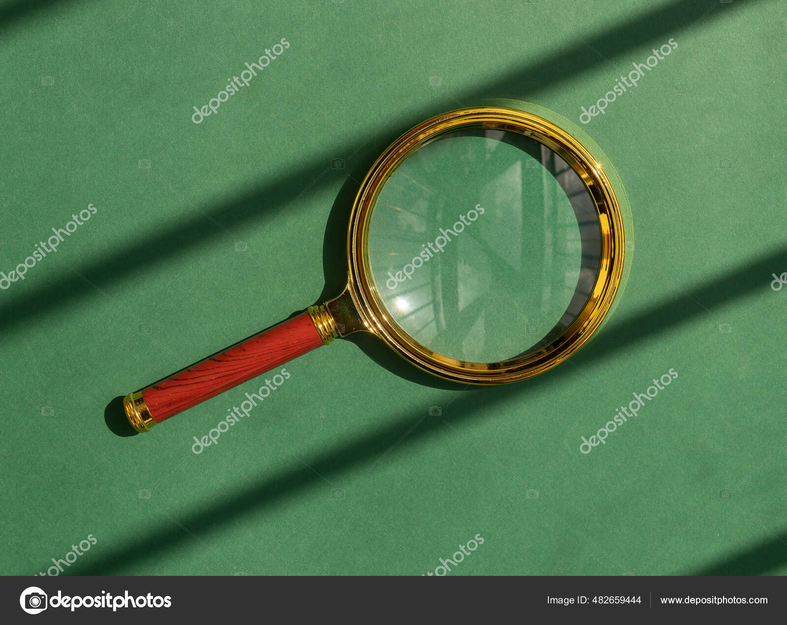 Magnifying glass over green background with sun light. Magnifier as ...