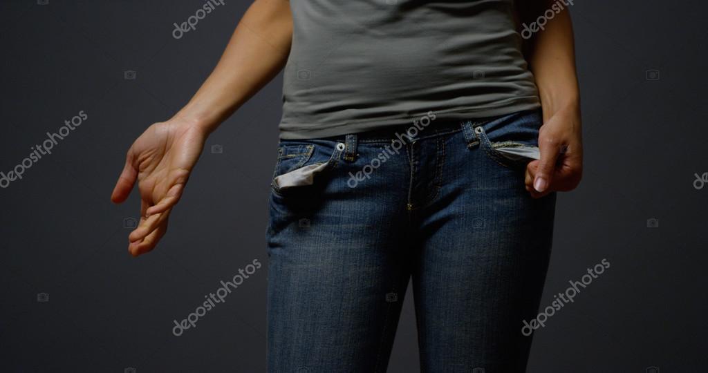 Woman in debt pulling out empty pockets Stock Photo by ©mark ...