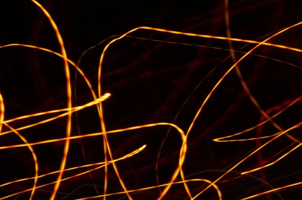 Gold threads on black background - abstract graphic background showing ...