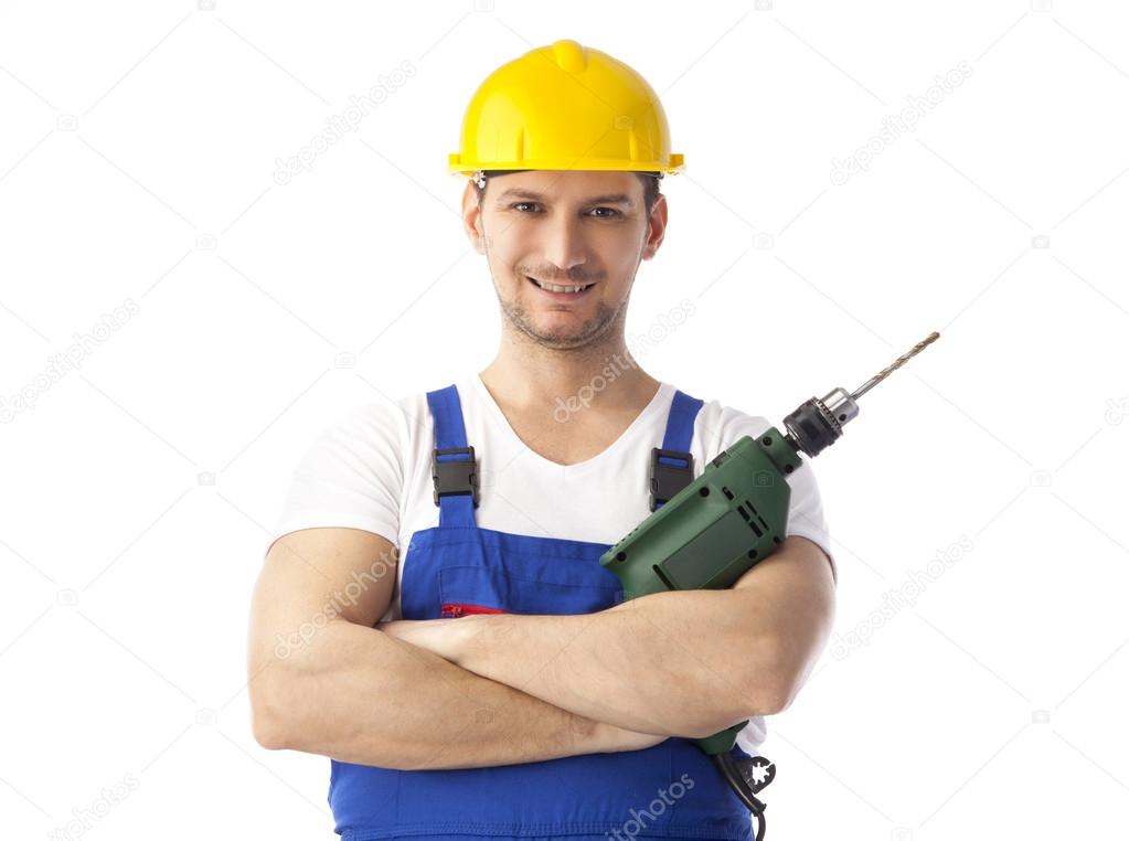 Smiling handyman holding drill machine Stock Photo by ©dragonstock ...