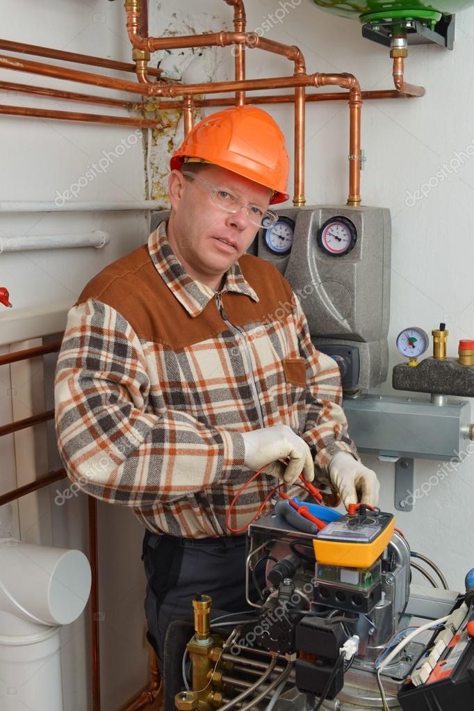 Service Man Working on Furnace Stock Photo by ©vision.si 56643615