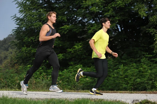 Two young athletes jogging / running in the park Stock Photo by ©vision ...