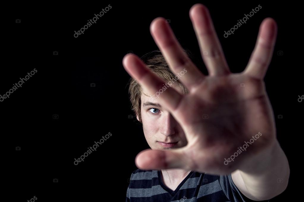 Image of a boy with his hand extended signaling to stop — Stock Photo ...