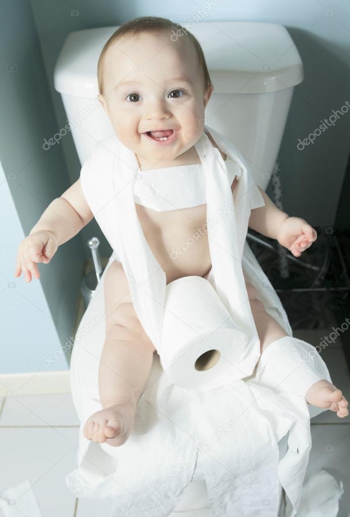 Toddler ripping up toilet paper in bathroom — Stock Photo © Lopolo ...